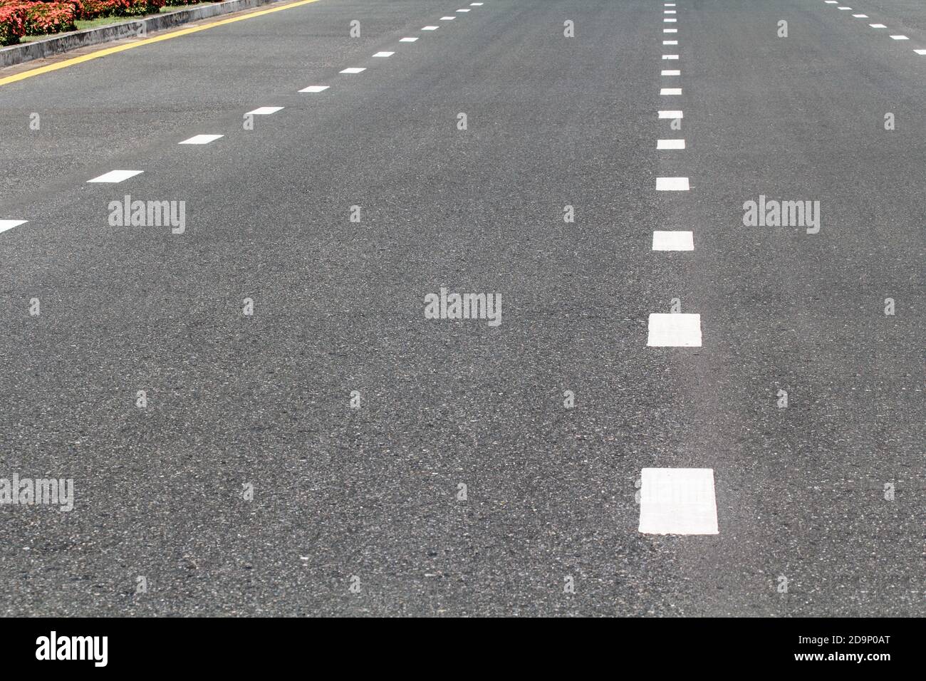 Dividing line on surface road Stock Photo - Alamy