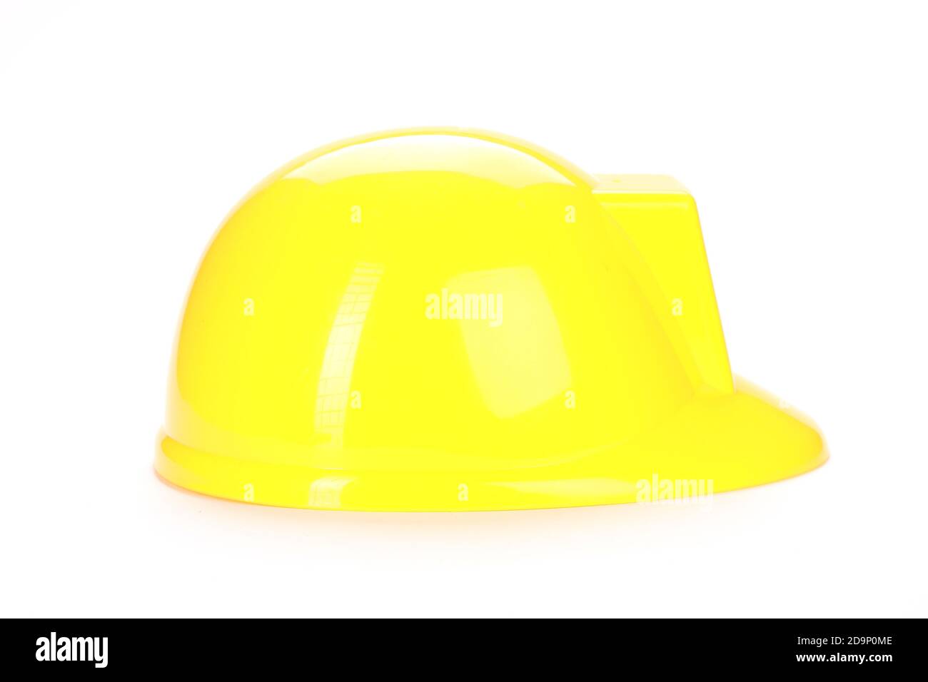A shiny yellow construction workers hat isolated on a white background ...