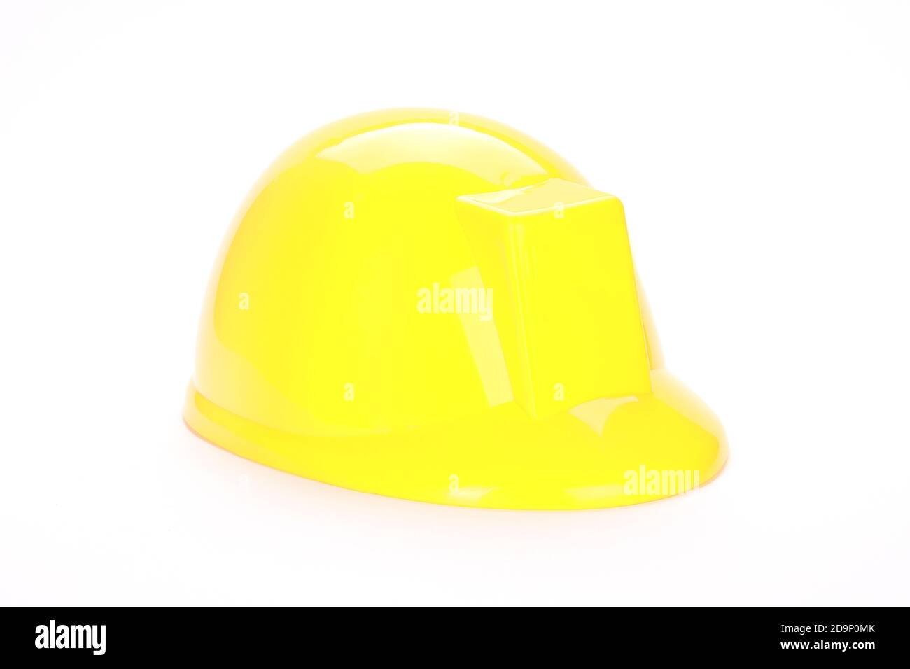 A shiny yellow construction workers hat isolated on a white background ...