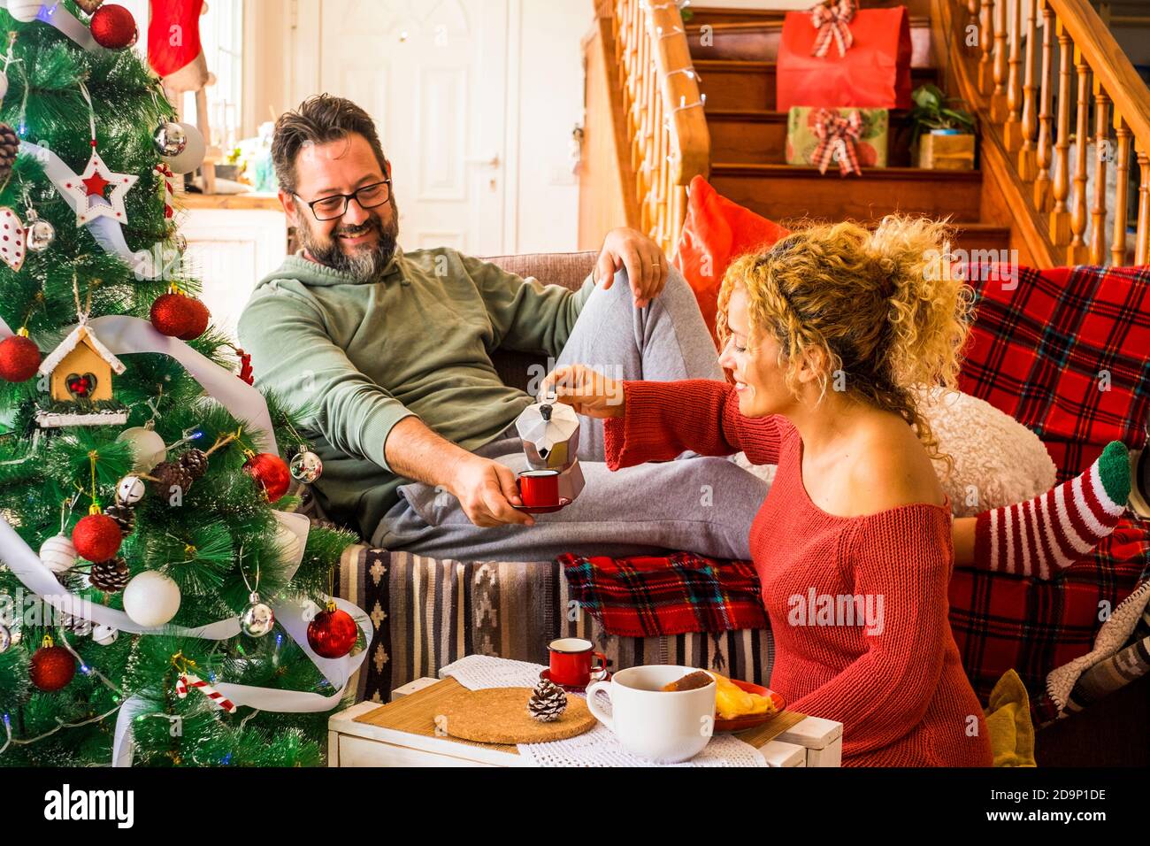 Christmas time at home with happy adult caucasian couple having ...
