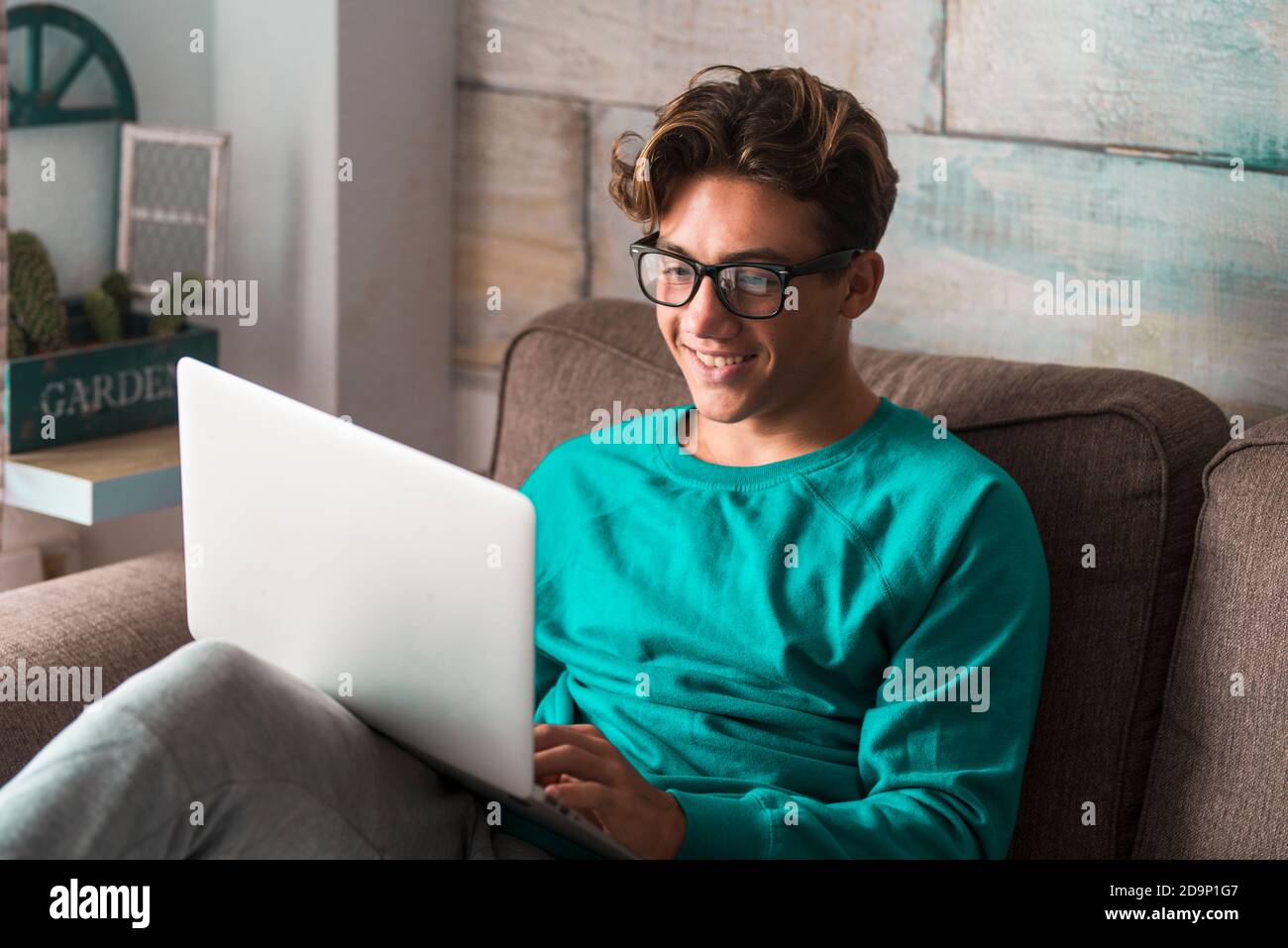Young caucasian student study at home with internet and laptop computer ...