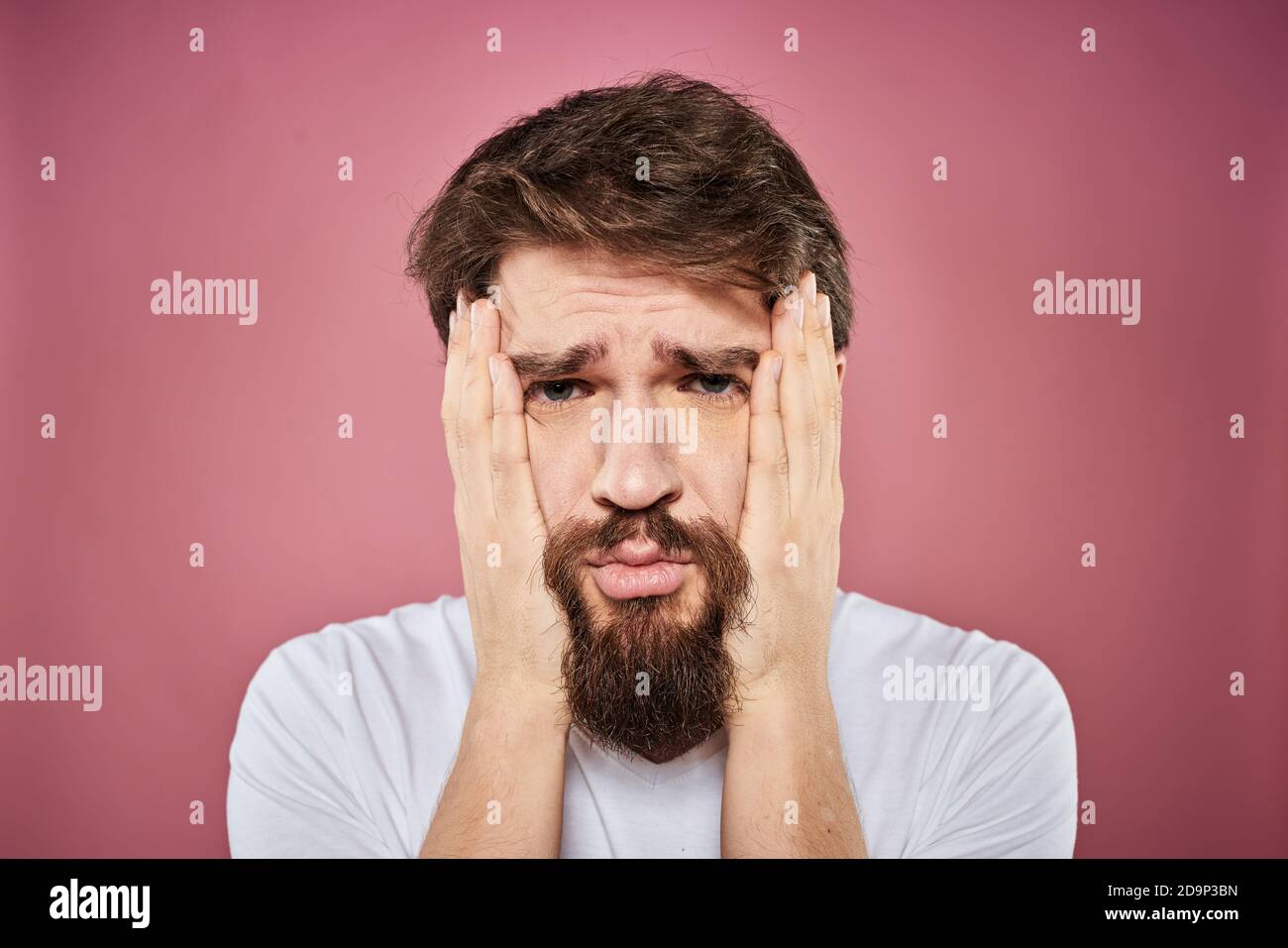 bearded man in white t-shirt emotions displeased facial expression ...