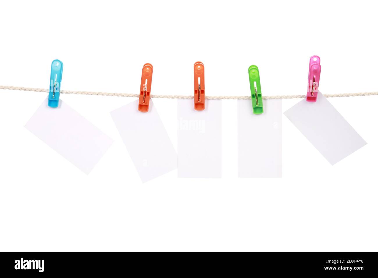 Collection of various pegs on white background Stock Photo - Alamy