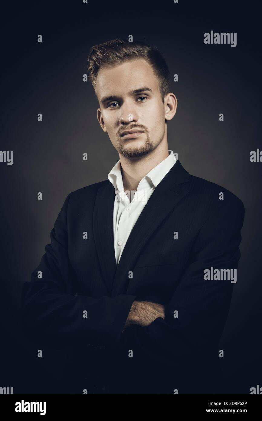Young man dressed in suit studio portrait Stock Photo - Alamy