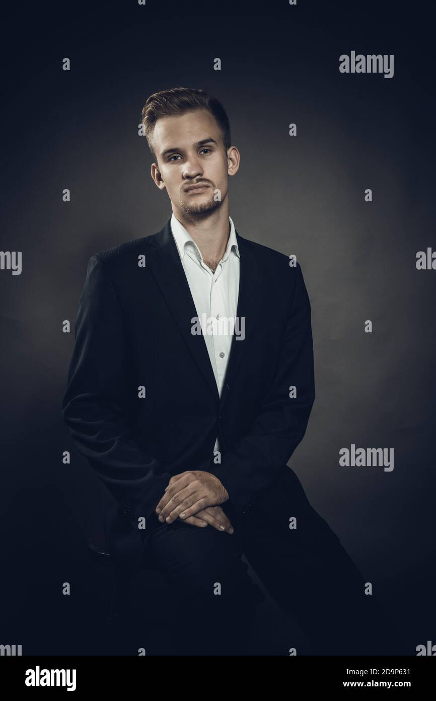 Young man dressed in suit studio portrait Stock Photo - Alamy