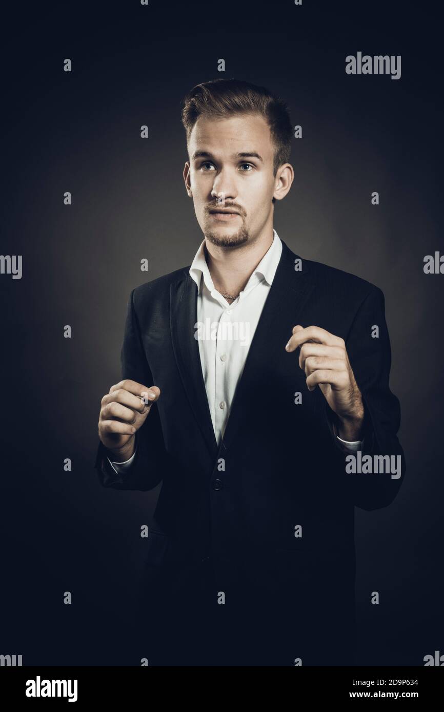 Young man dressed in suit studio portrait Stock Photo - Alamy