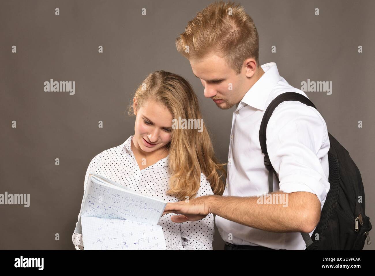 Two students young man and woman watching papers studio portrait Stock ...