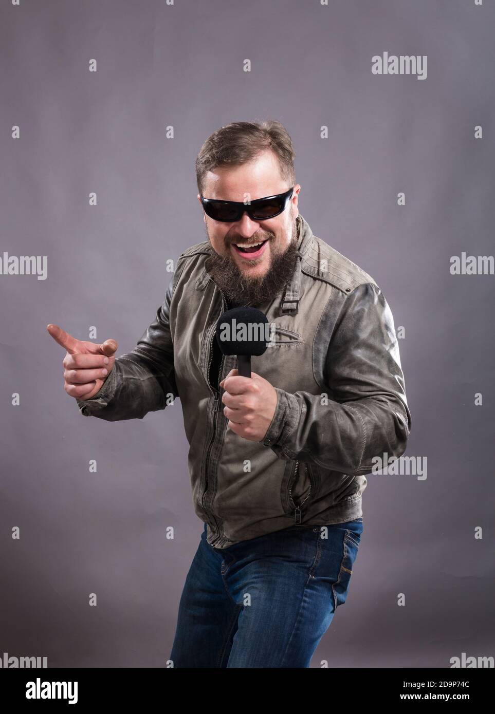 Bearded emotional rock singer with micriphone studio portrait Stock ...