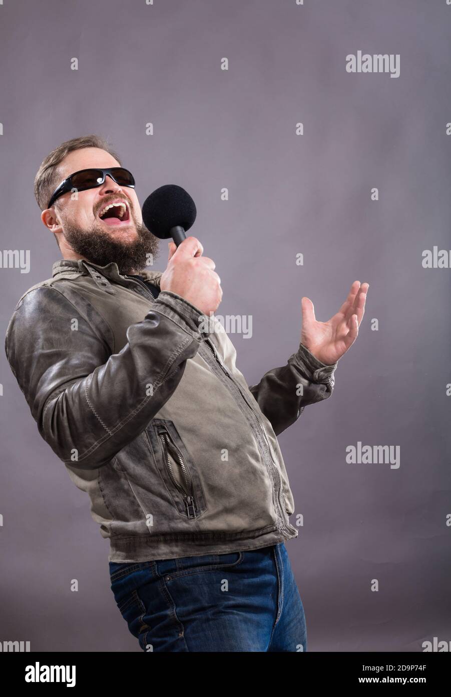 Bearded emotional rock singer with micriphone studio portrait Stock ...