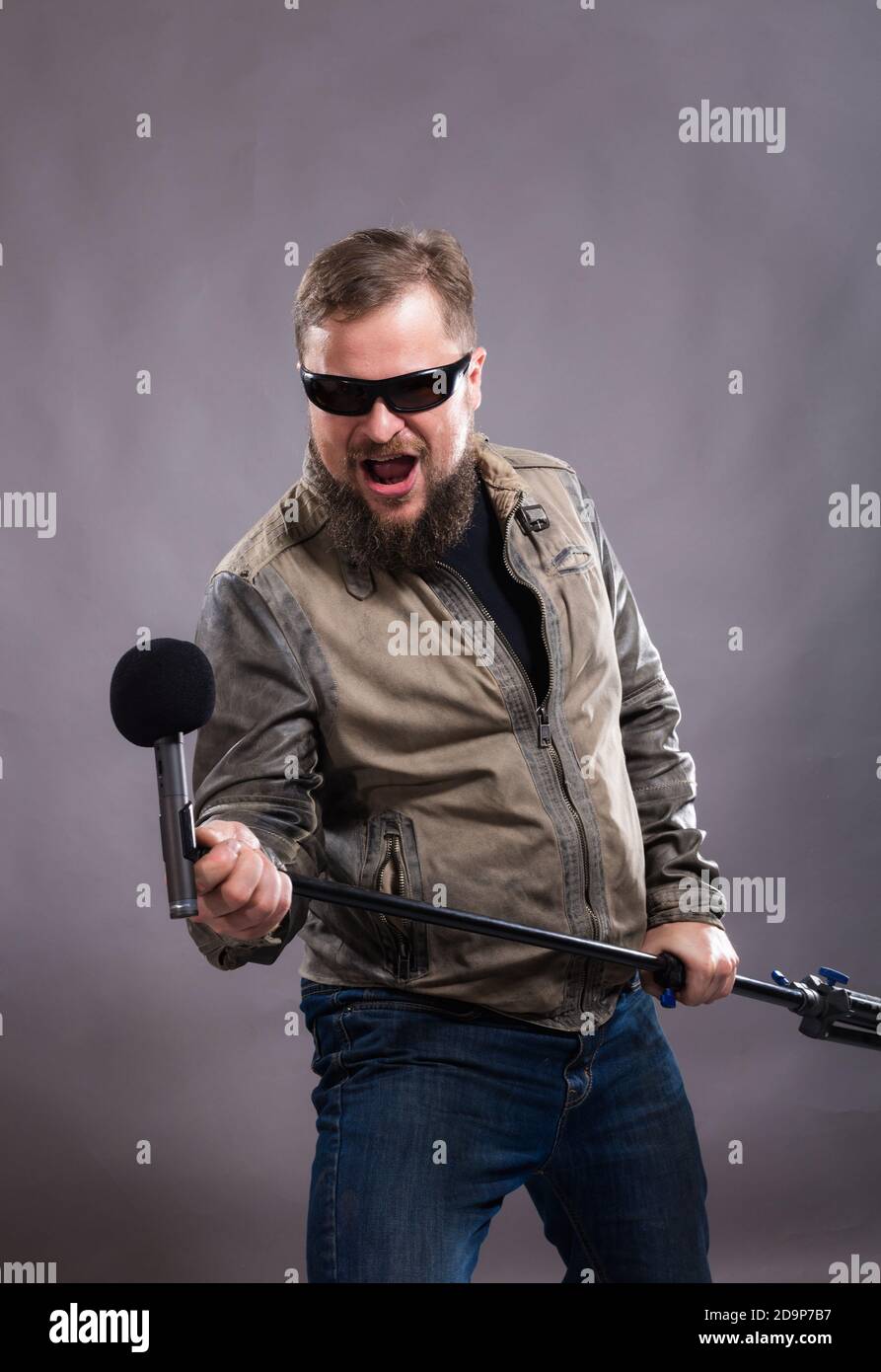 Bearded emotional rock singer with micriphone studio portrait Stock ...