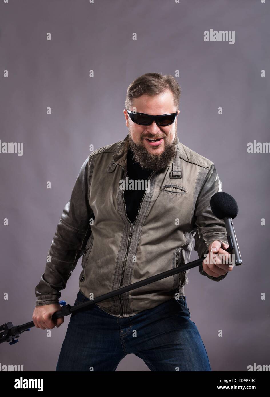 Bearded emotional rock singer with micriphone studio portrait Stock ...