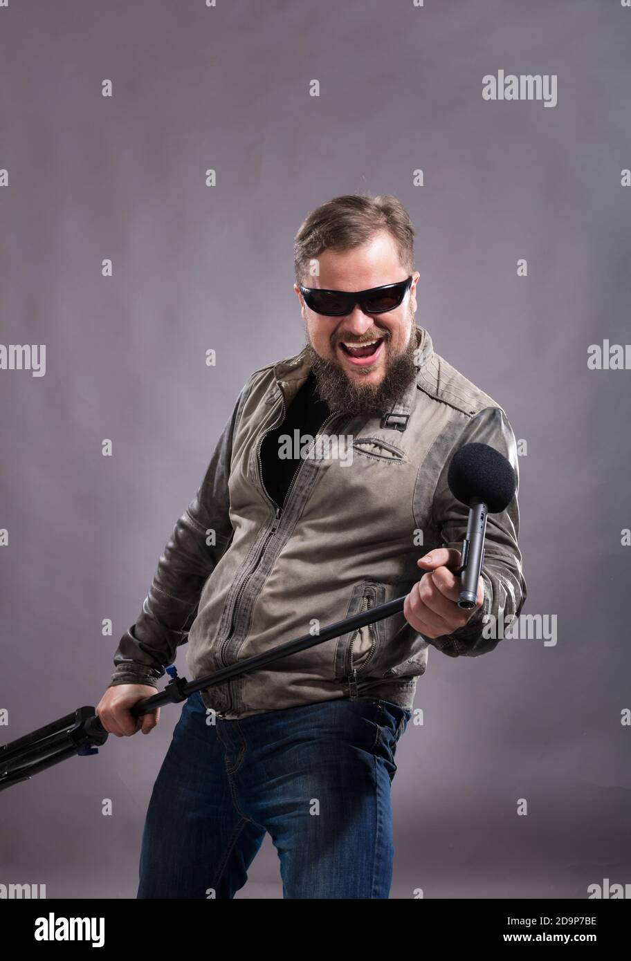 Bearded emotional rock singer with micriphone studio portrait Stock ...