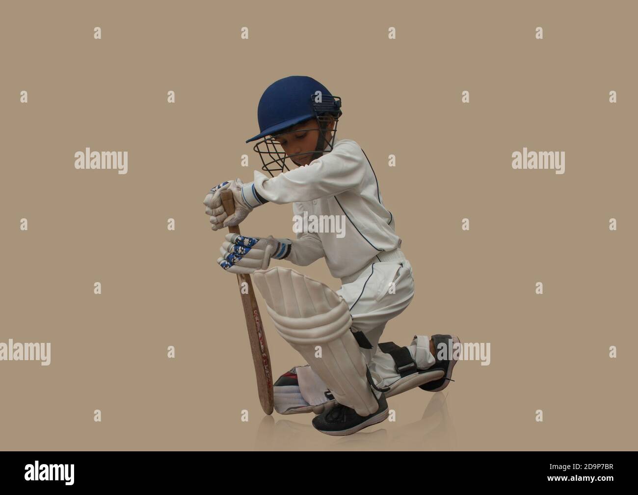 A boy in cricket uniform playing Cricket Stock Photo - Alamy