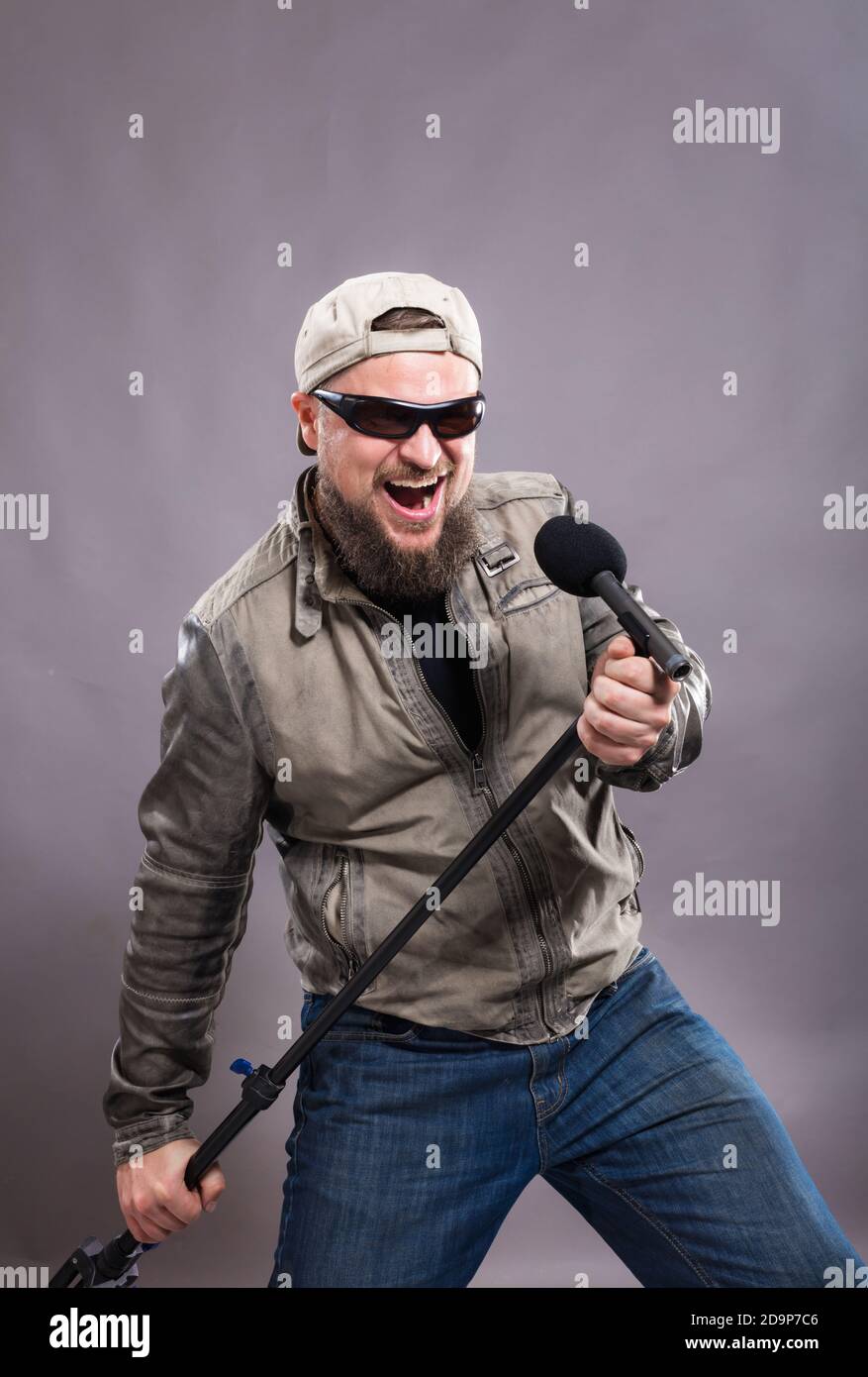 Bearded emotional rock singer with micriphone studio portrait Stock ...