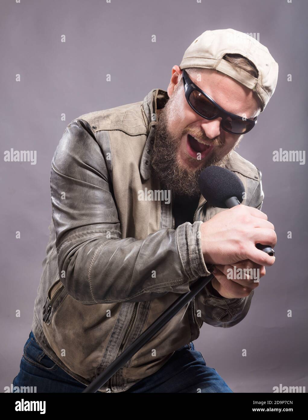 Bearded emotional rock singer with micriphone studio portrait Stock ...