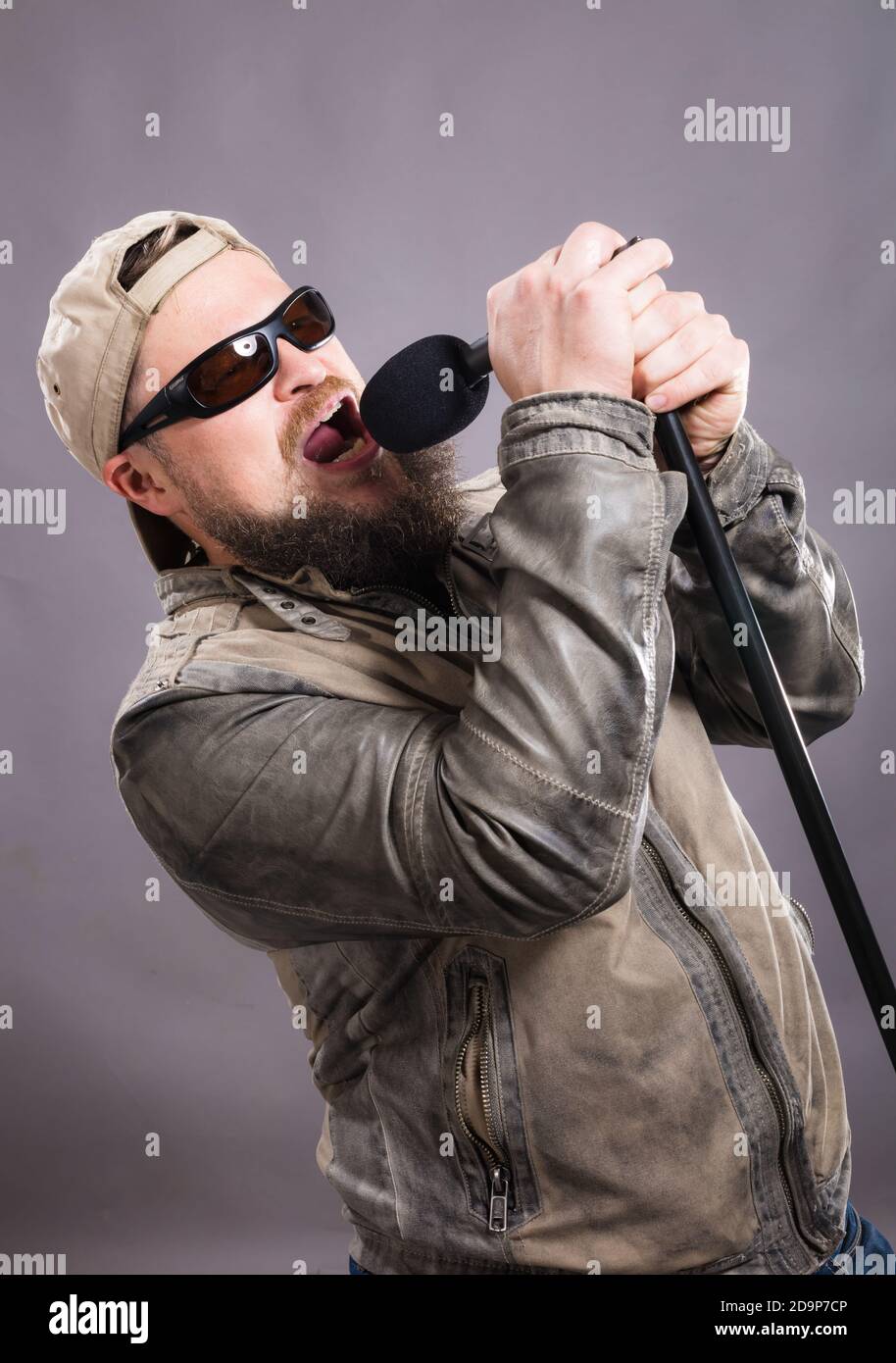 Bearded emotional rock singer with micriphone studio portrait Stock ...