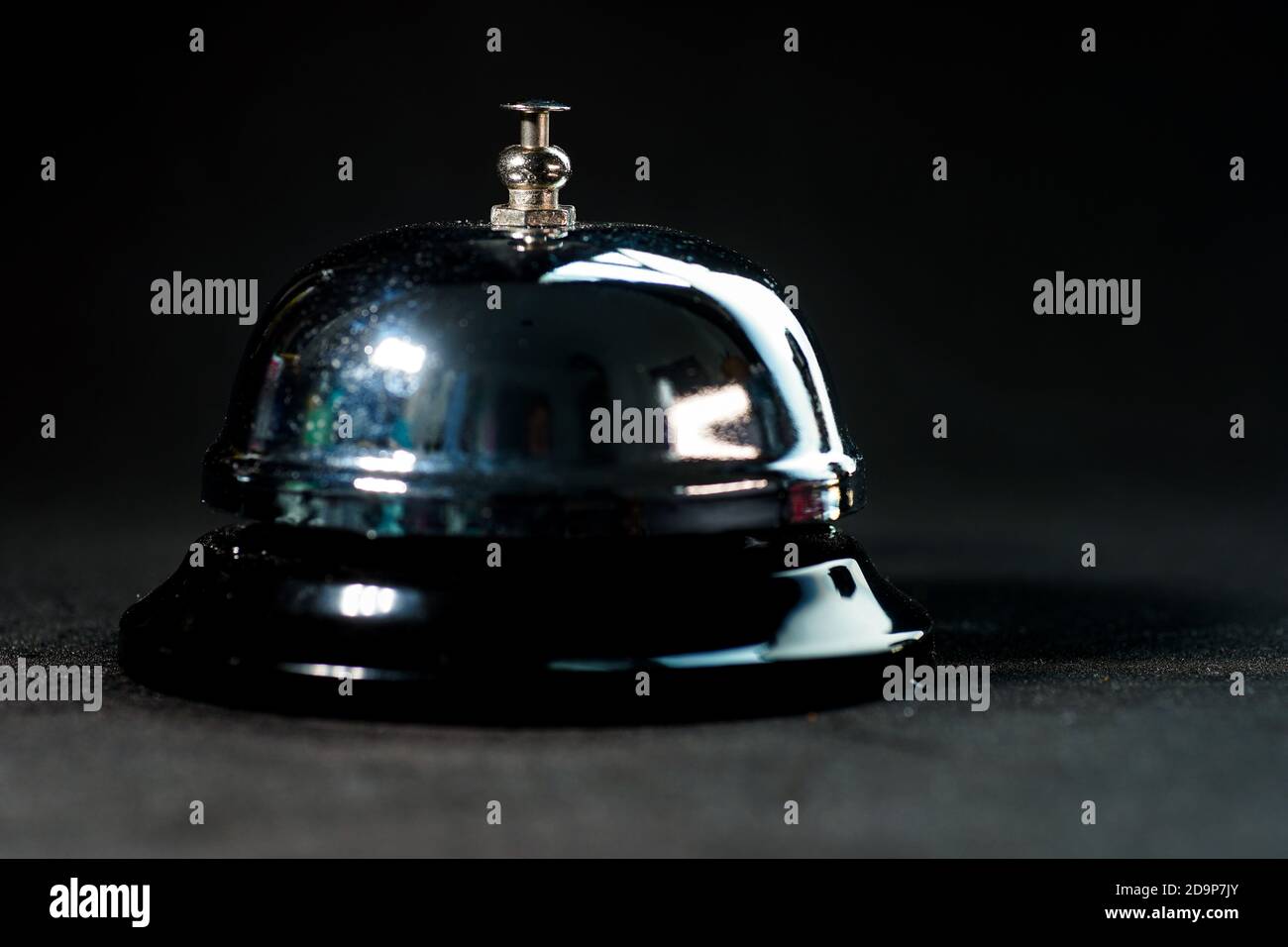 Reception Bell isolated against black background Stock Photo - Alamy