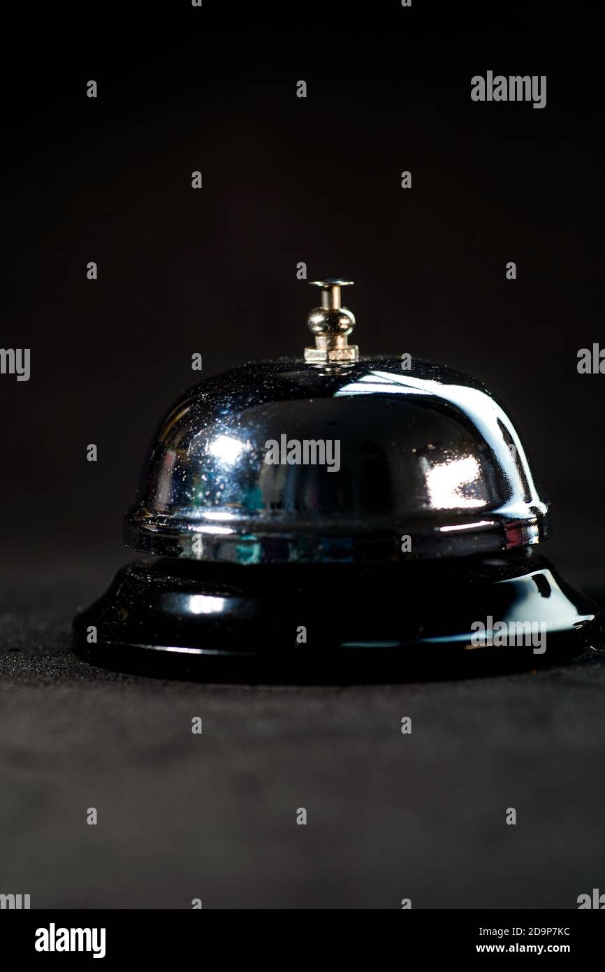 Reception Bell isolated against black background Stock Photo - Alamy