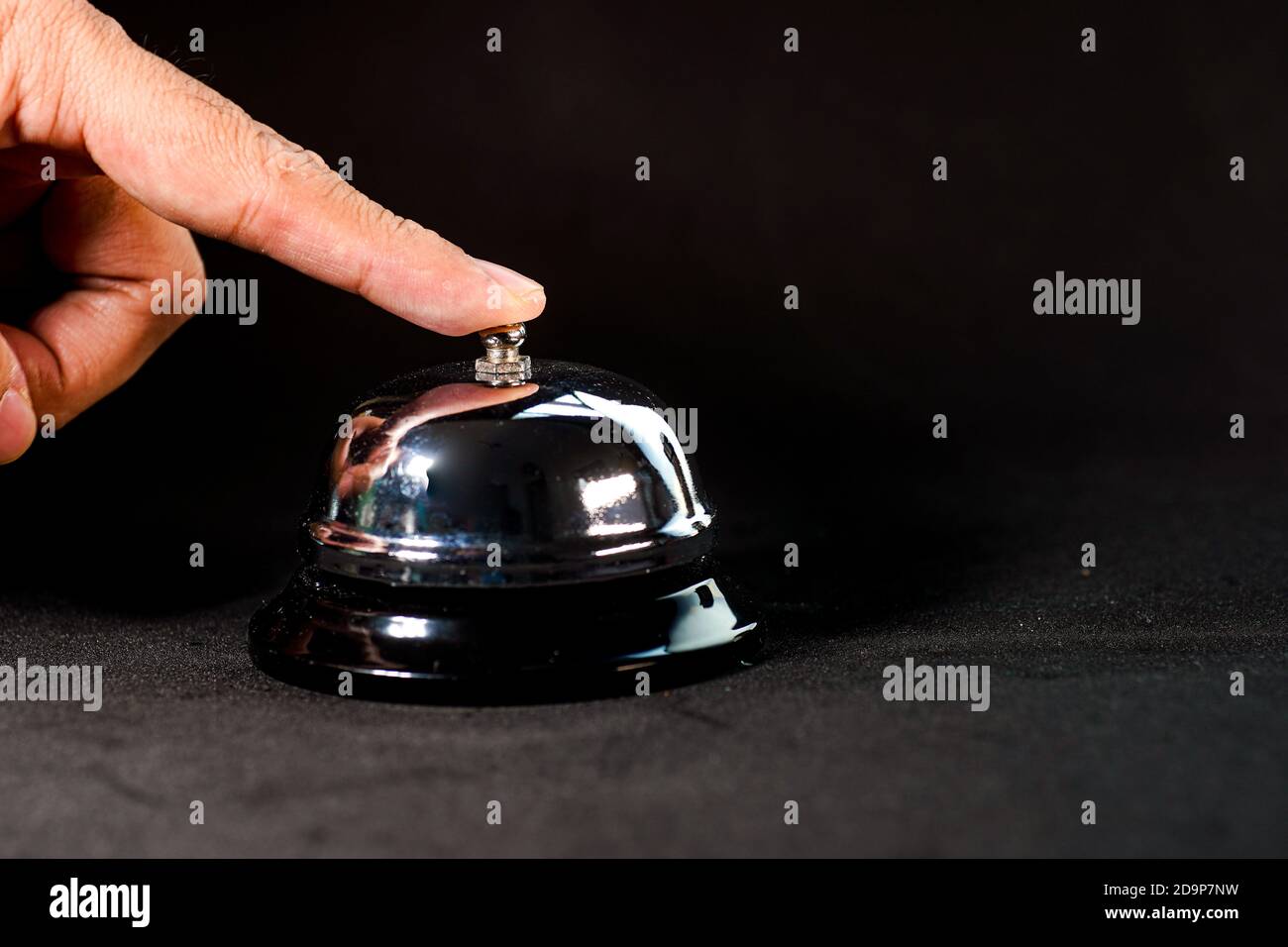 Reception Bell isolated against black background Stock Photo - Alamy