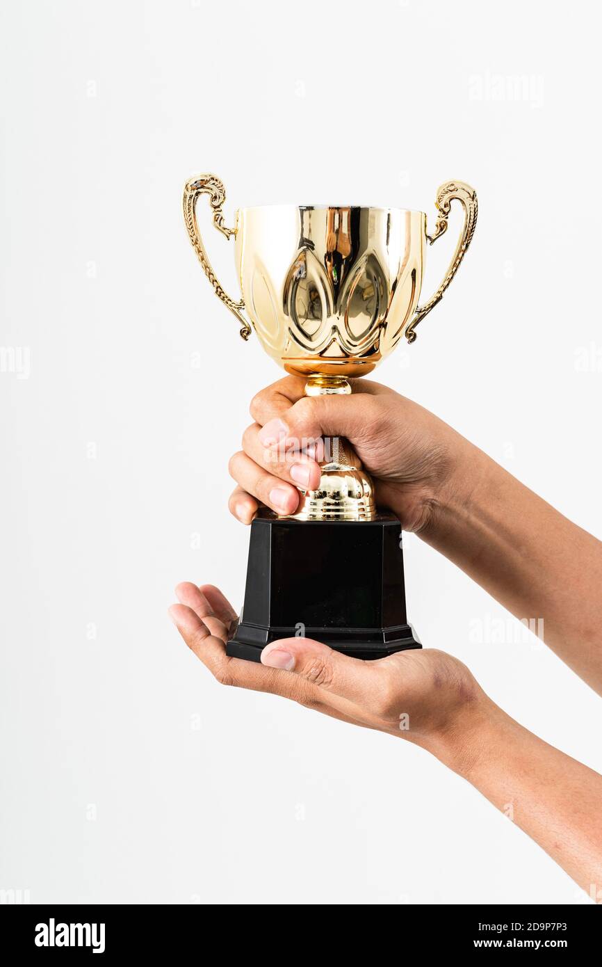 A man’s hand holding a trophy against isolated white background Stock ...