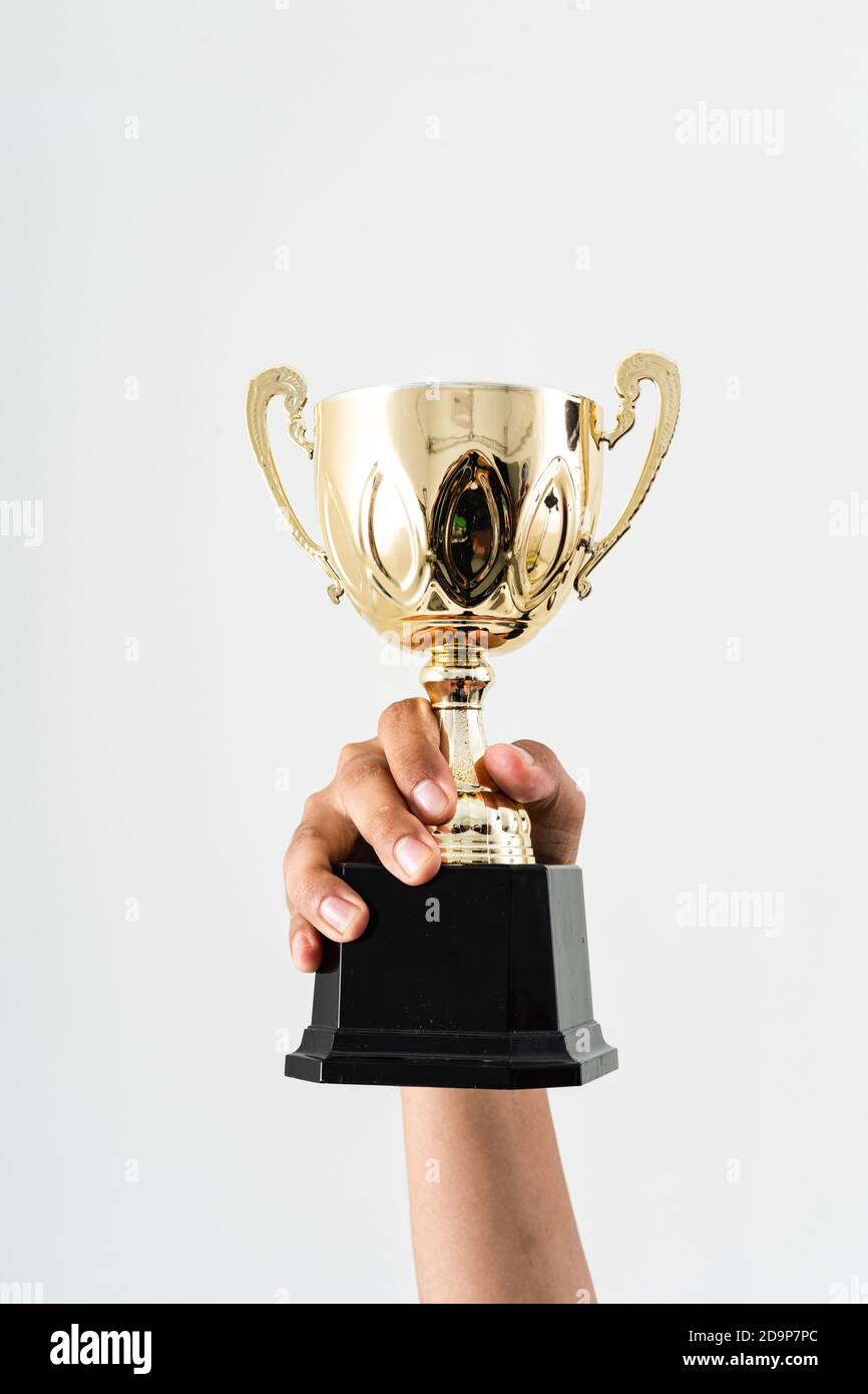 A man’s hand holding a trophy against isolated white background Stock ...