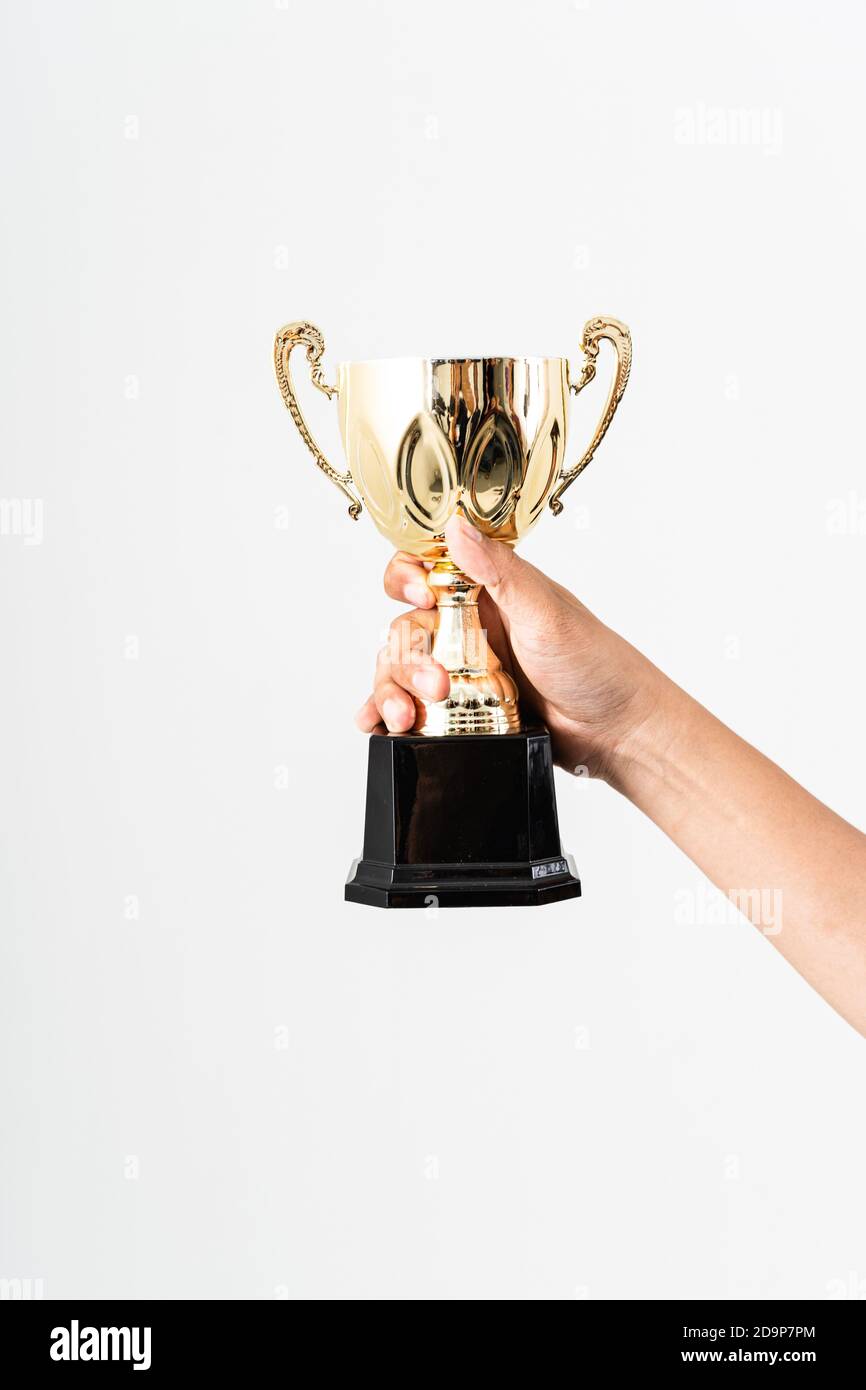 A man’s hand holding a trophy against isolated white background Stock ...