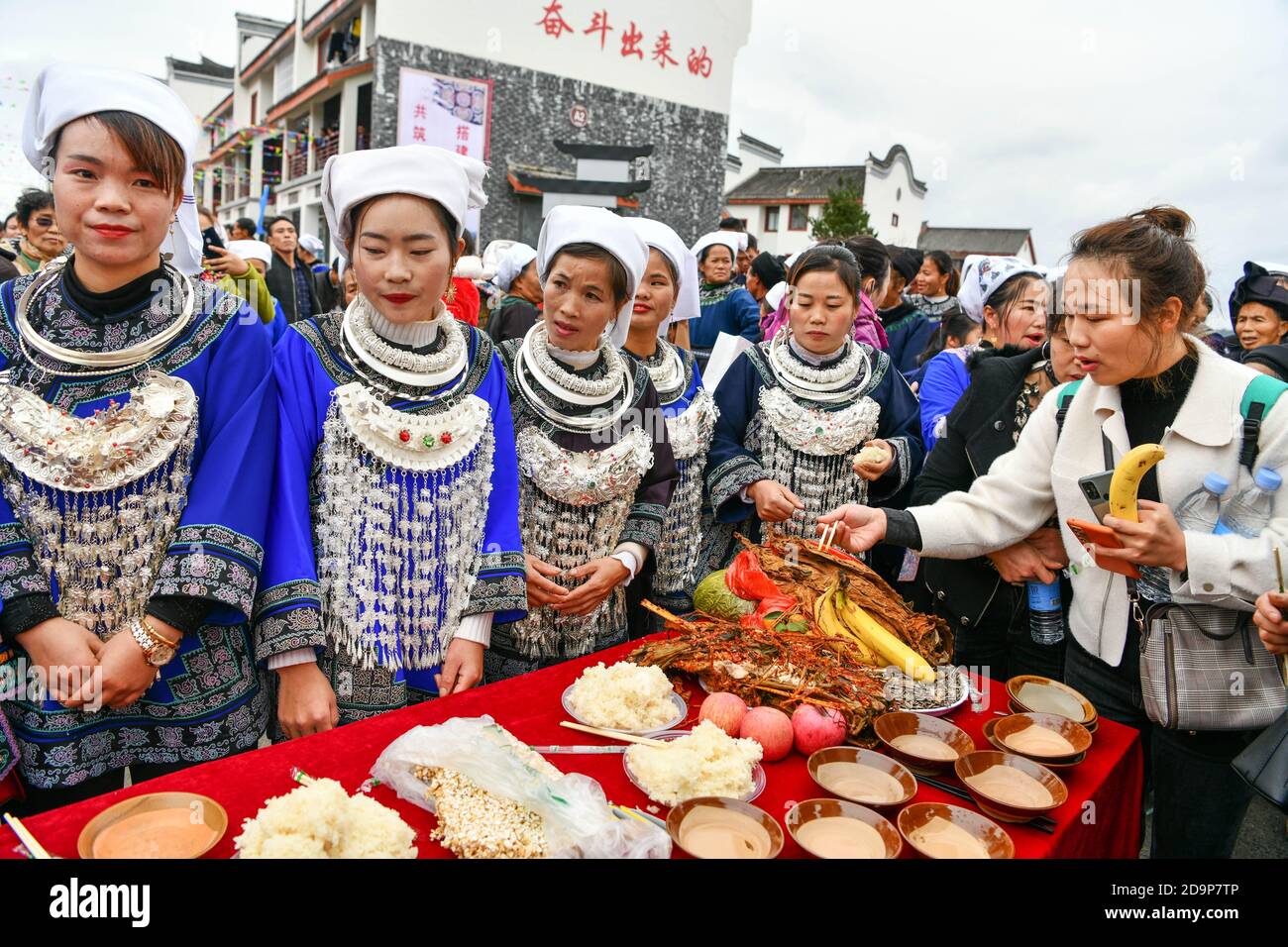 Sandu, China's Guizhou Province. 6th Nov, 2020. People share food after ...