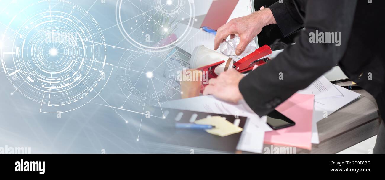 Disorganized businessman looking for documents on his messy desk ...