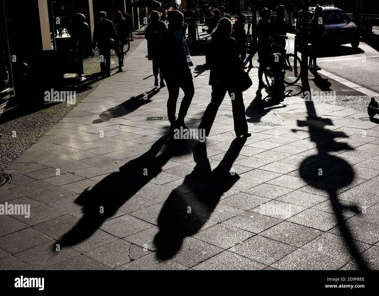 Berlin, Germany. 04th Nov, 2020. Passers-by and a traffic light pole ...