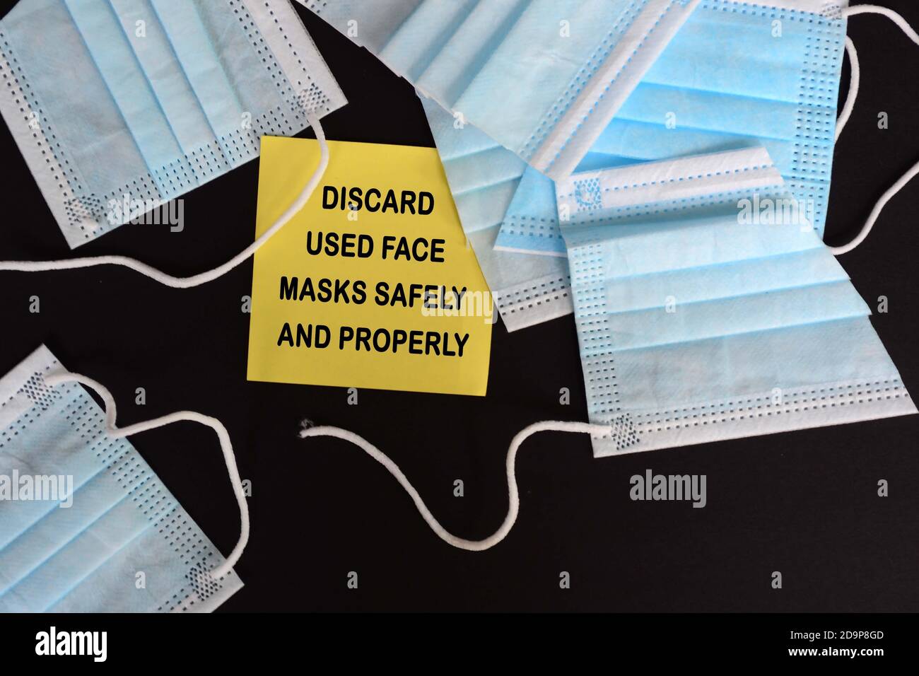 Guidance and advice for disposal of face mask written on yellow sticky ...