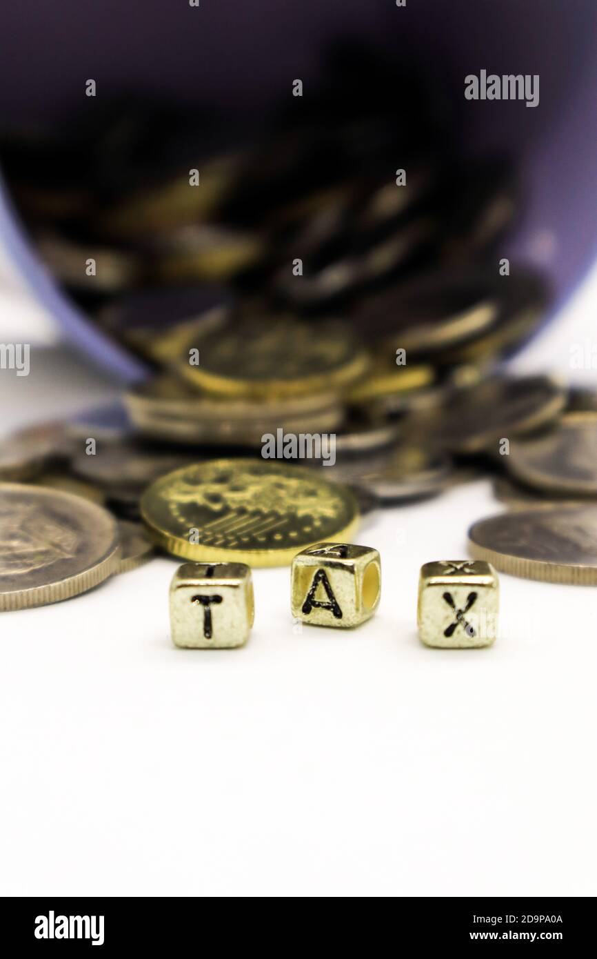 “TAX” wording on a stack of coins, isolated Stock Photo - Alamy