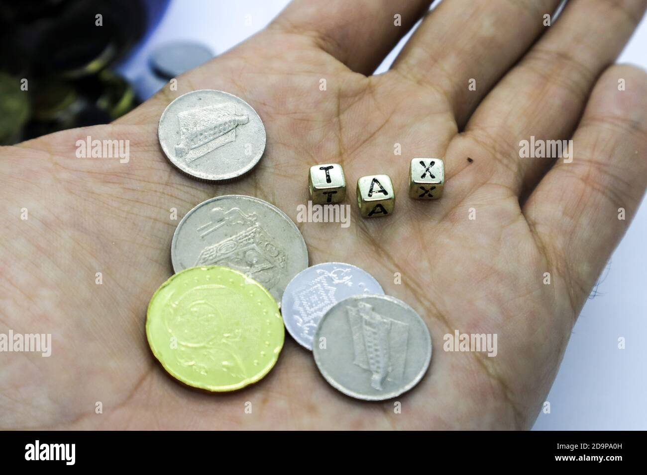 “TAX” wording on a stack of coins, isolated Stock Photo - Alamy