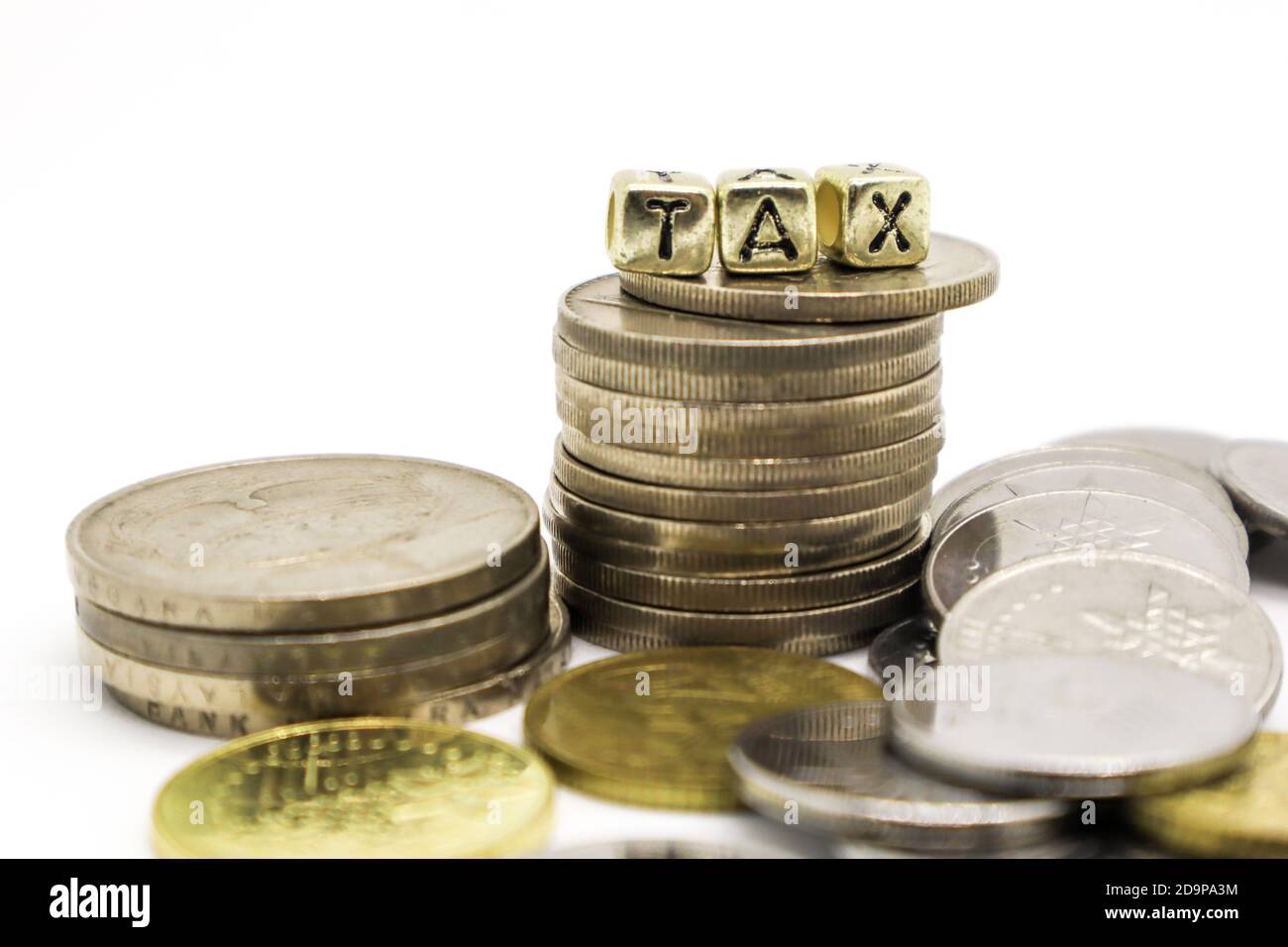 “TAX” wording on a stack of coins, isolated Stock Photo - Alamy