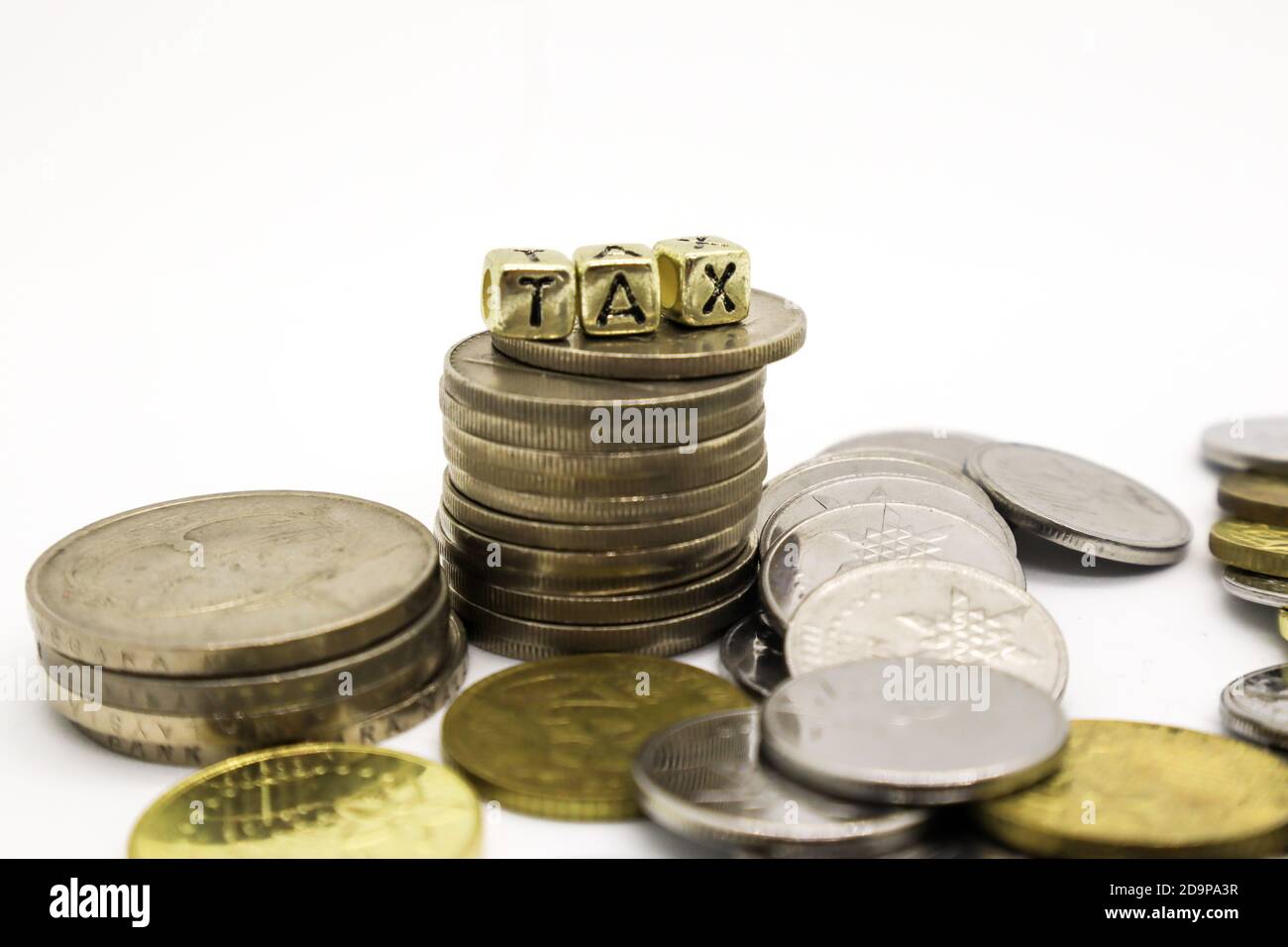 “TAX” wording on a stack of coins, isolated Stock Photo - Alamy