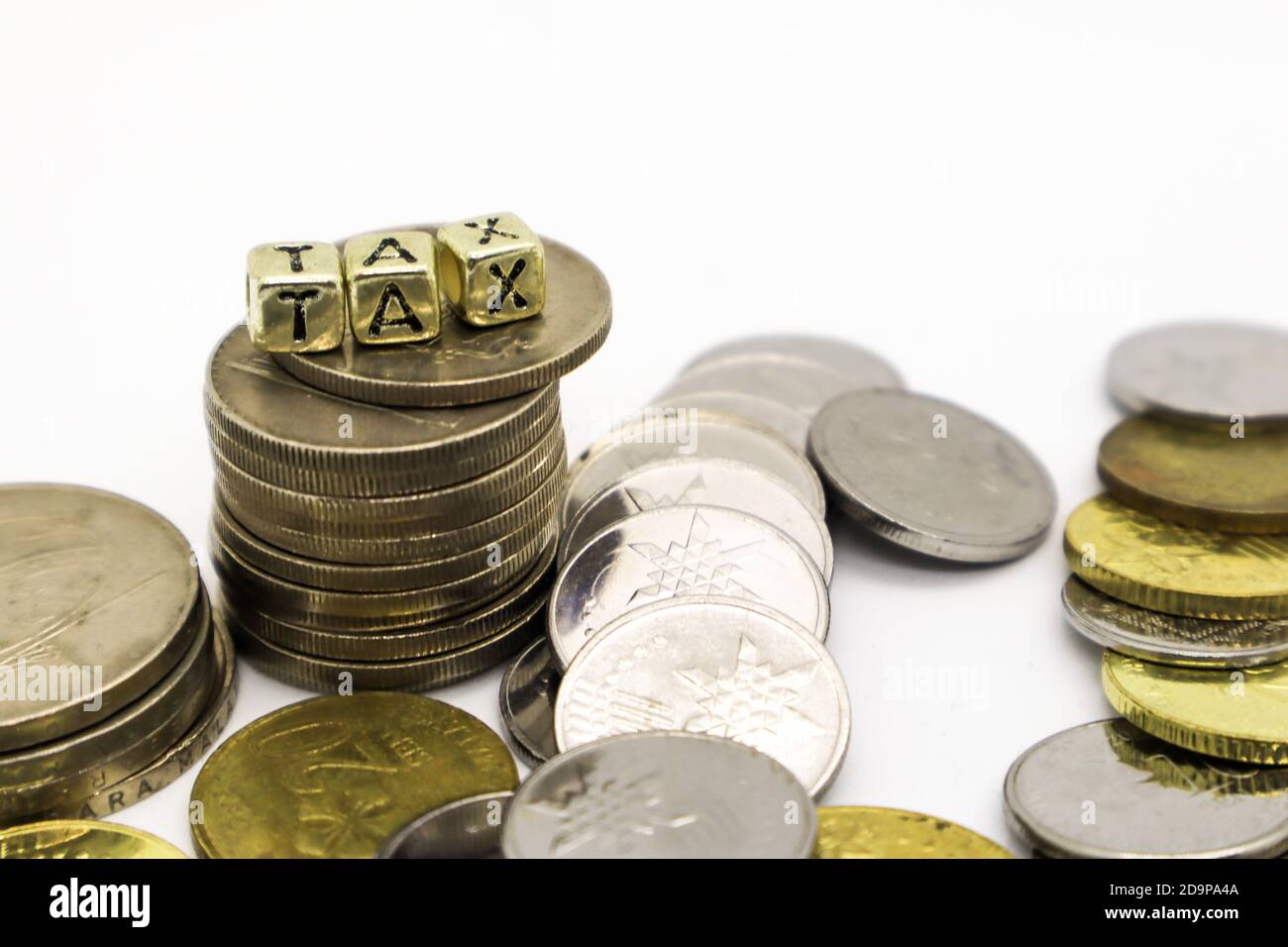 “TAX” wording on a stack of coins, isolated Stock Photo - Alamy