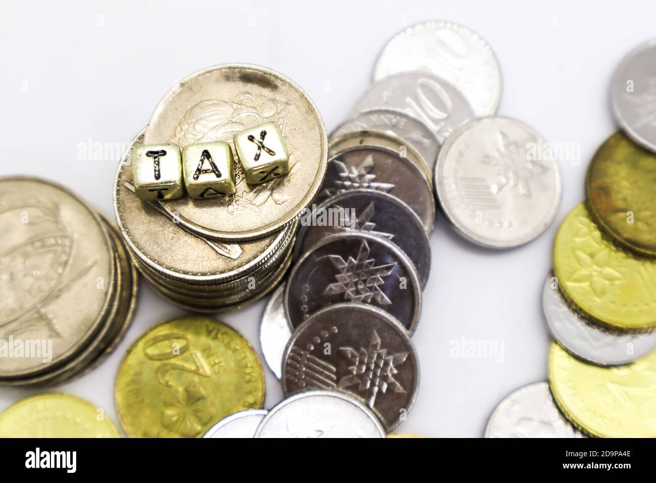 “TAX” wording on a stack of coins, isolated Stock Photo - Alamy