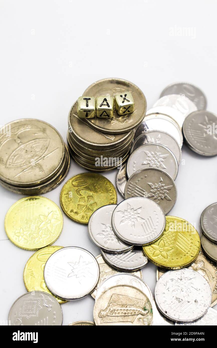 “TAX” wording on a stack of coins, isolated Stock Photo - Alamy