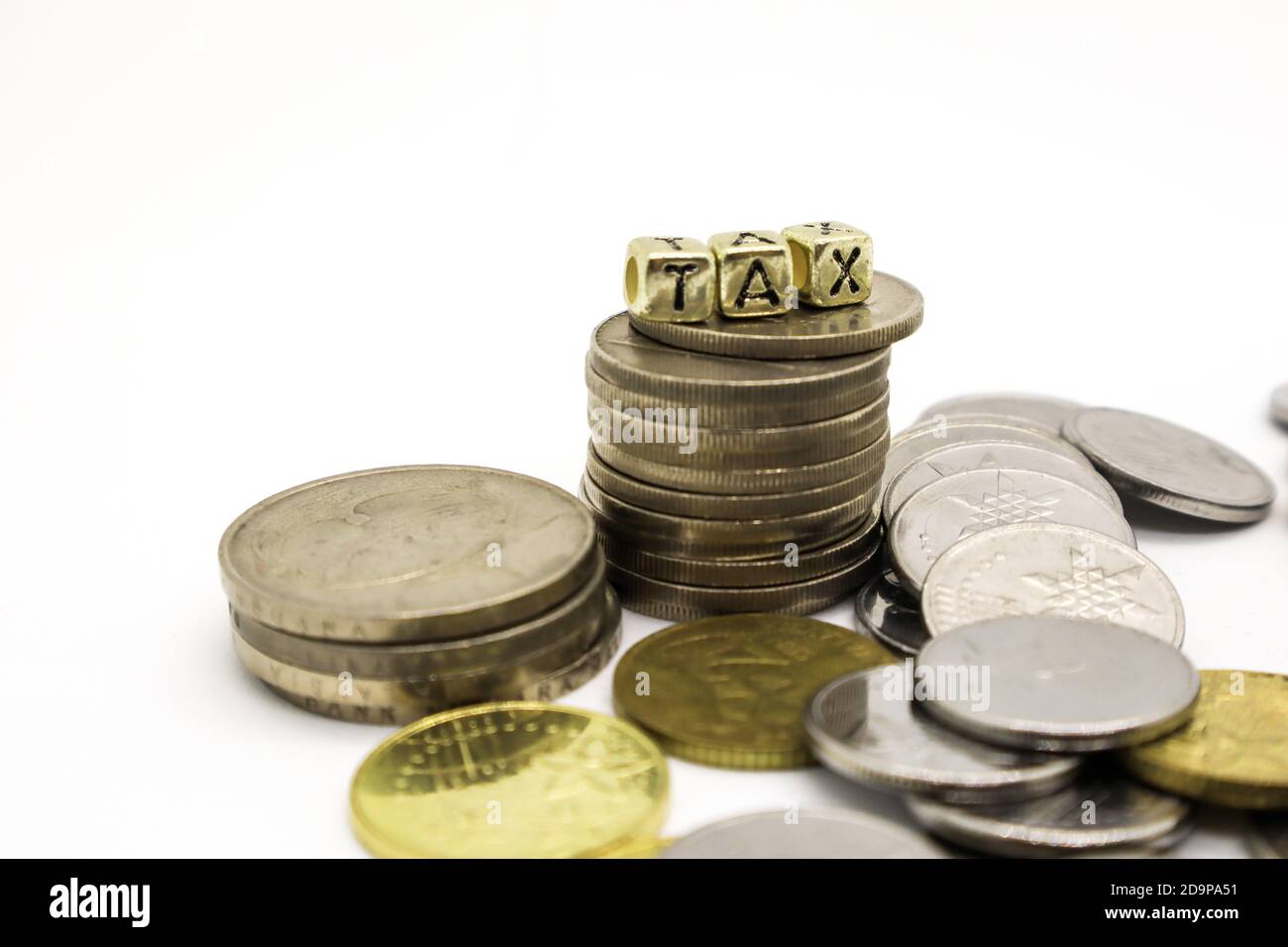 “TAX” wording on a stack of coins, isolated Stock Photo - Alamy