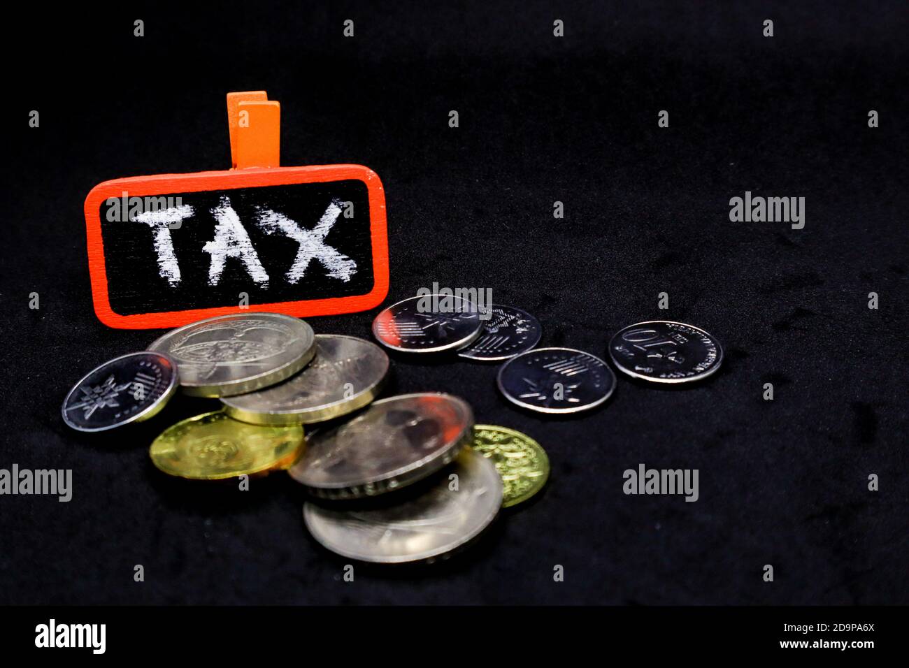 “TAX” wording on a stack of coins, isolated Stock Photo - Alamy