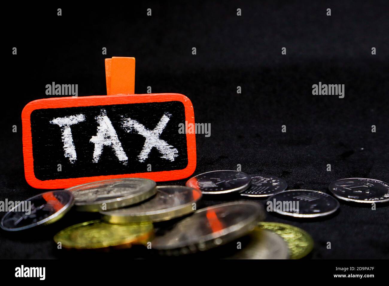 “TAX” wording on a stack of coins, isolated Stock Photo - Alamy