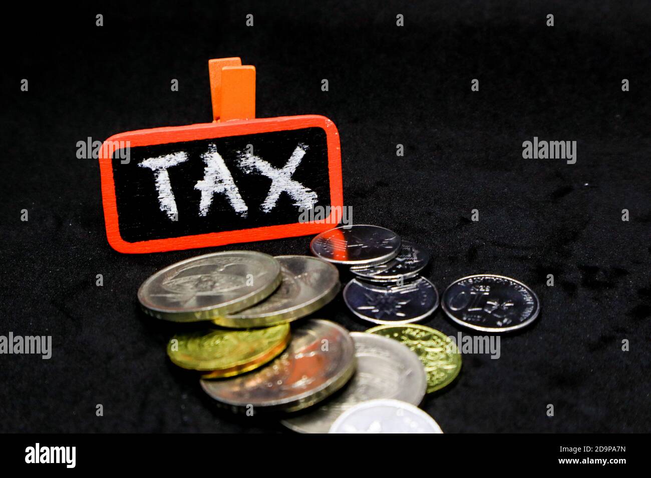 “TAX” wording on a stack of coins, isolated Stock Photo - Alamy