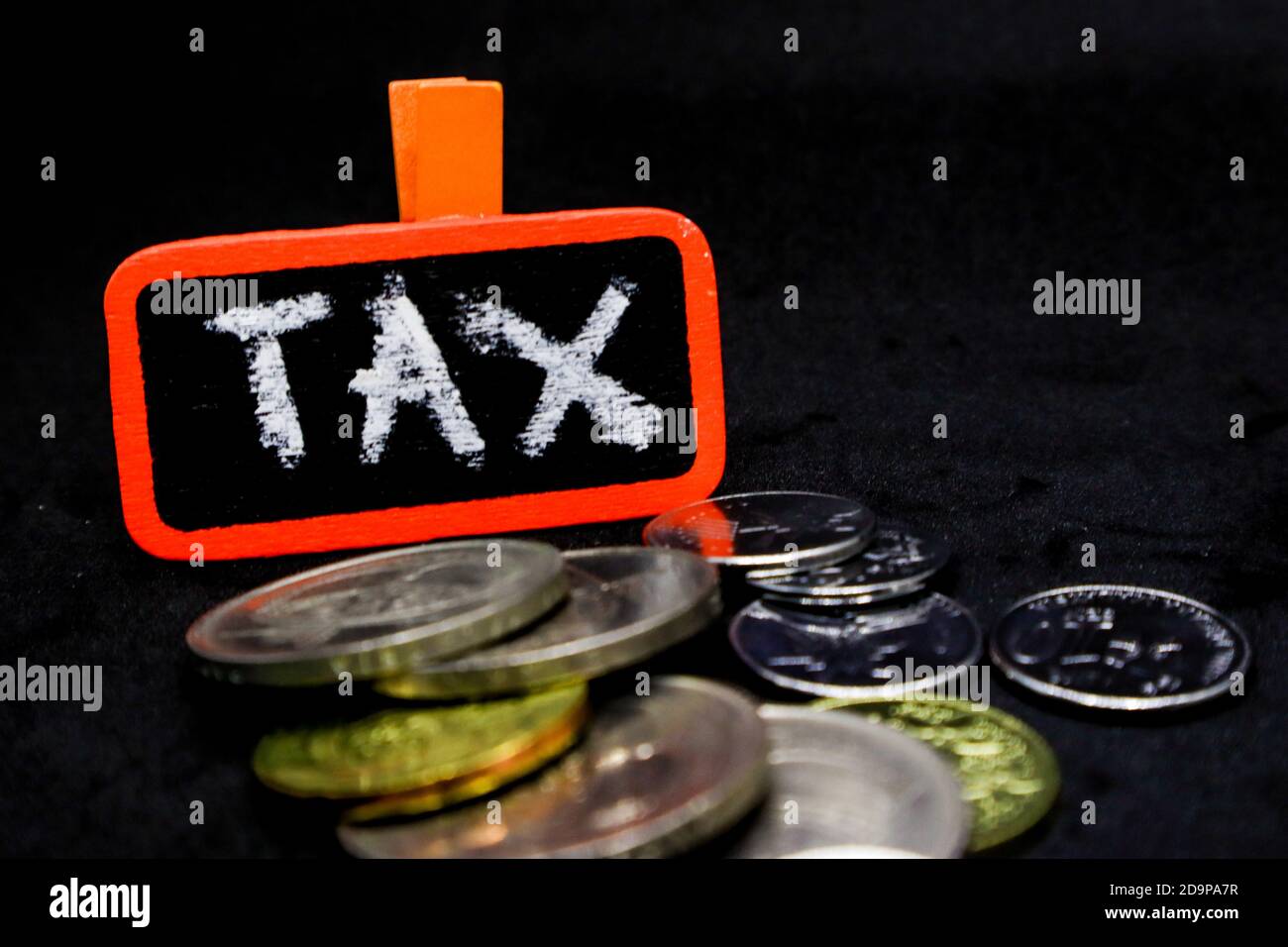 “TAX” wording on a stack of coins, isolated Stock Photo - Alamy