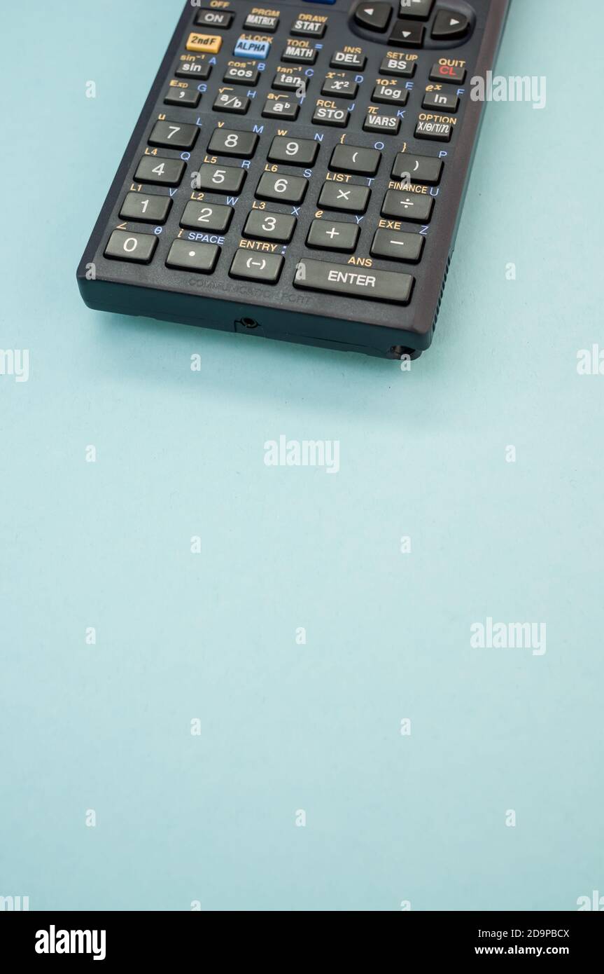 Vertical shot of a calculator on a blue background Stock Photo - Alamy