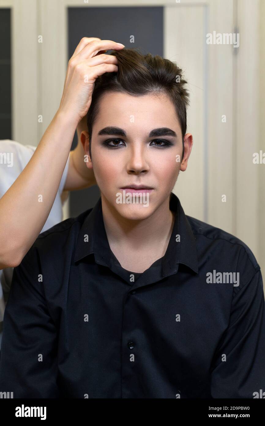 stylist prepares the guy model for the show. men's makeup for show ...