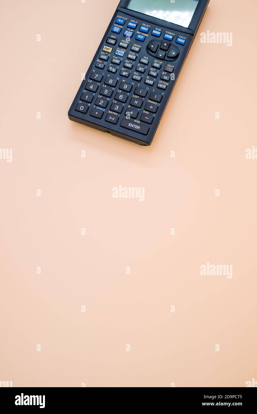 Vertical shot of a calculator on a peachy background Stock Photo - Alamy