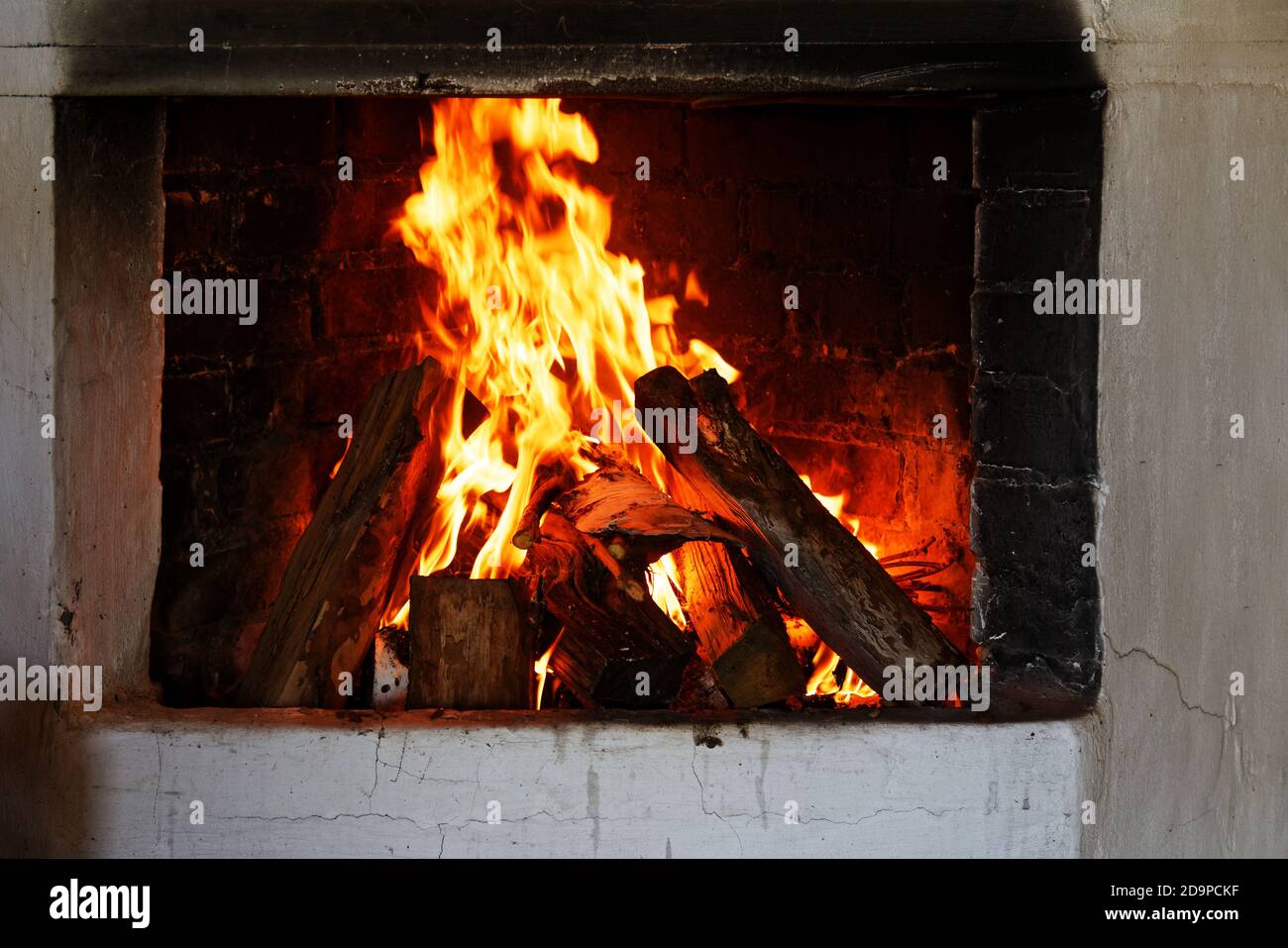 Firewood burning in the rural rustic hearth Stock Photo - Alamy