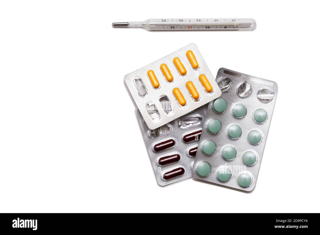 Packs of pills and thermometer isolated on white Stock Photo - Alamy