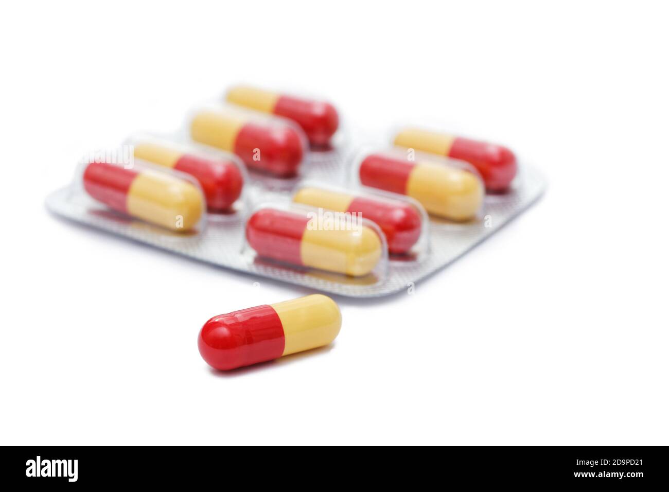 Closeup medicine red and yellow capsule and pack of that pills on ...