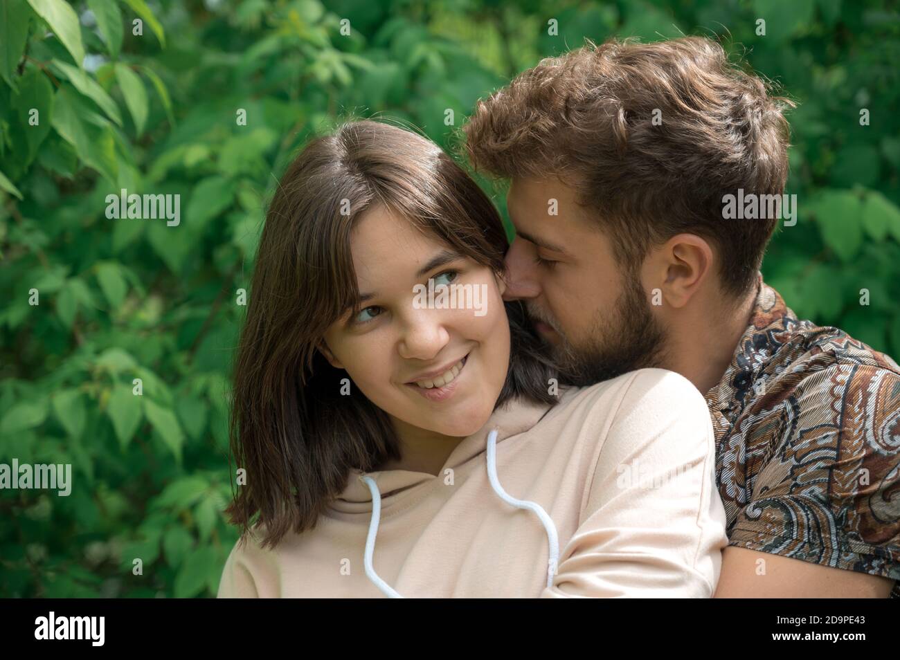 In love relationships of tender couple. Man flirts his girlfriend, she ...