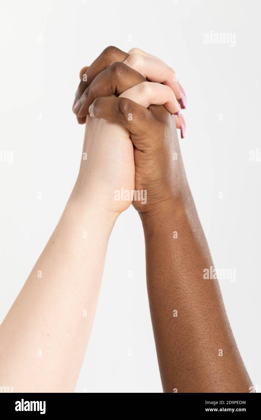 Clasped in a loving embrace, the hands of two loving women raised up ...